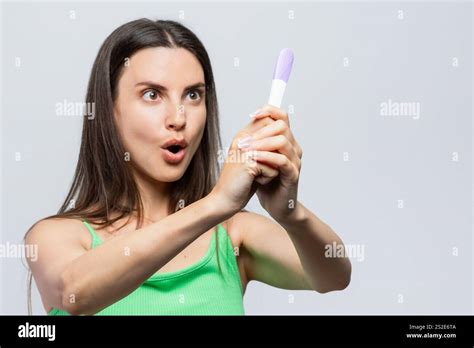 Young Woman Discovers The Result Of Her Pregnancy Test And Seems Shocked Isolated On White