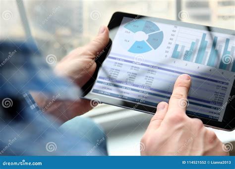 Business Man Working And Analyzing Financial Figures On A Graphs On A Laptop In The Office Stock