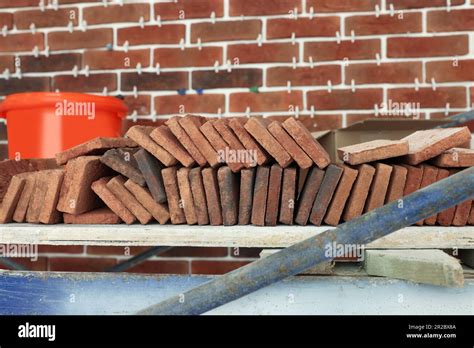Many Decorative Bricks On Scaffolding Near Wall Tiles Installation