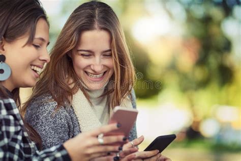 Check This Out Two Attractive Young Women Using Their Cellphones While