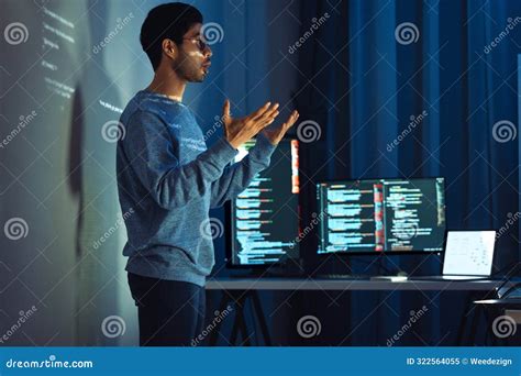 Indian Man Programmer Standing In Front Of A Screen With Code Projected