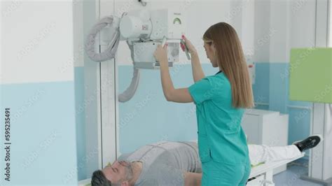 Female Doctor Sets Up The Machine To X Ray Over Patient Radiologist