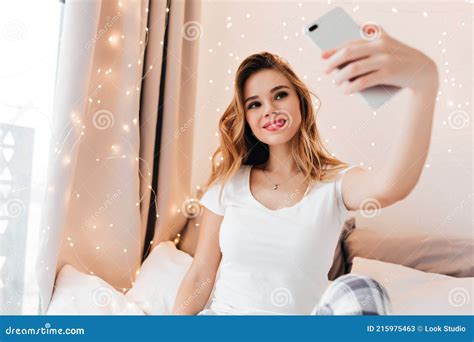 Glamorous Girl With Dark Makeup Making Selfie In Bedroom Indoor Shot