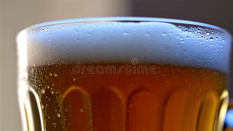 A Frosty Glass Of Cold Beer With Condensation Dripping Down The Sides