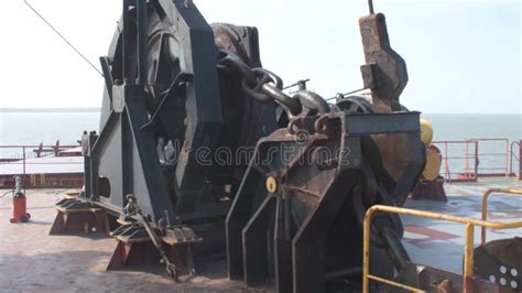 Anchor Chain Heaving Up Over Gypsy Of Windlass Of A Cargo Ship While