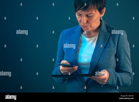 Smartphone And Tablet Data Synchronization Businesswoman Syncing Files And Documents On