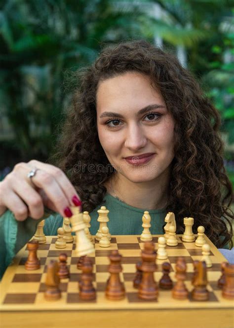 Close Up Face Cute Young Girl Seen Through Chessboard As She Holds