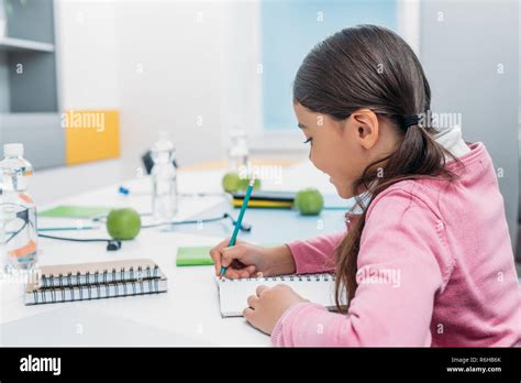 Babegirl Writing In Notebook During Lesson In Classroom Stock Photo Alamy