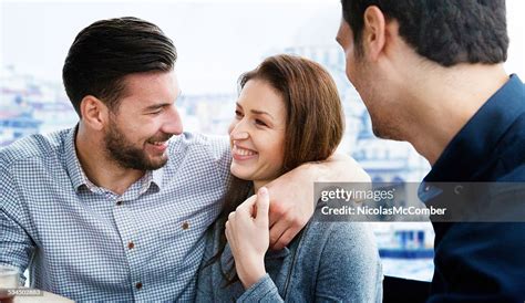 Young Couple Connect On Istanbul Cruise In Front Of Friend High Res