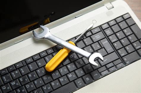 Premium Photo Wrench And Screwdriver With A Laptop Computer It Service Support