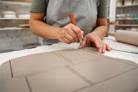 Cutting Out Rectangle Figures Out Of A Flat Sheet Of Clay With A Shaping Knife Using A Clay