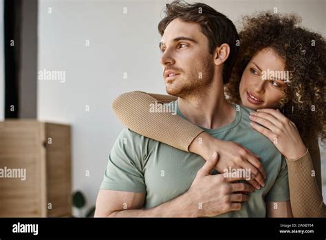 Affectionate Morning Embrace Of A Curly Young Woman And Brunette Man