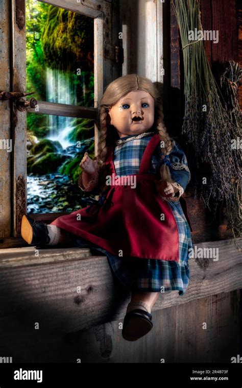 Antique Porcelain Doll On A Rustic Window Sill With A View Of The