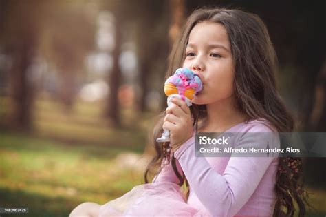 귀여운 금발의 곱슬머리 소녀가 공원에서 멋진 아이스크림을 먹고 아이들의 날을 생각하고 공간을 복사한다 4 5세에 대한 스톡 사진