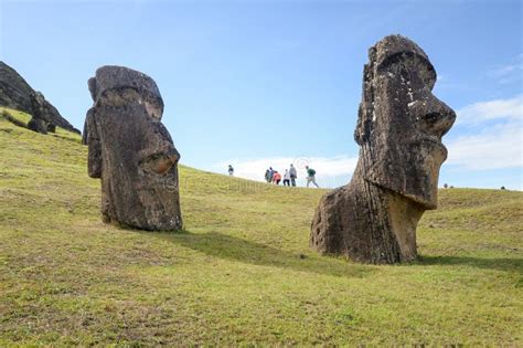 Tourists Exploring The Famous Moai Statues On Easter Island Chile