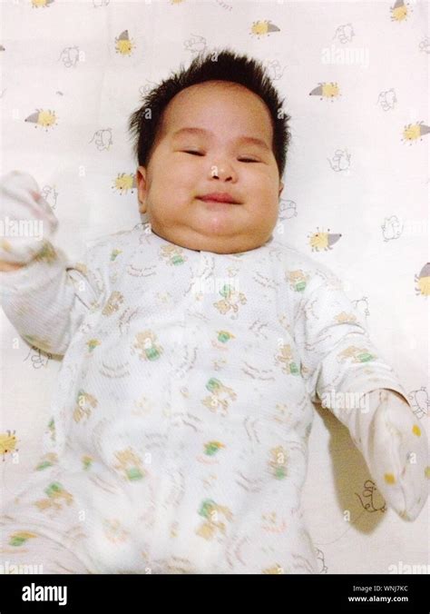 Portrait Of Baby Girl Lying On Bed Hi Res Stock Photography And Images