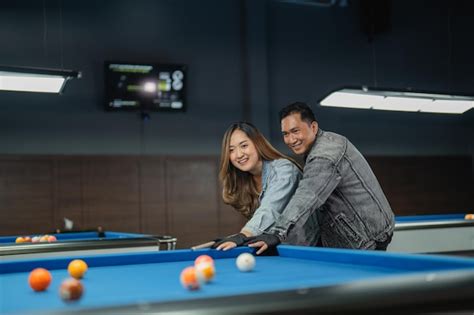 premium photo male pool player teaching the female cue player to