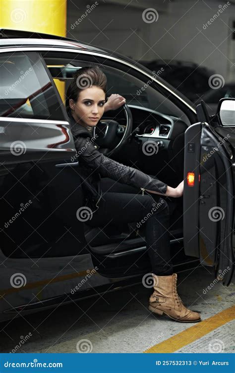 Stylish Chic In Her Luxury Car A Gorgeous Leather Clad Woman Sitting In Her Luxury Vehicle