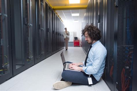 Premium Photo Team Of Young Technicians Working Together On Servers