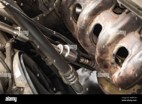 The Workflow Of Screwing A Car Oxygen Sensor On A Car Engine Close Up Stock Photo Alamy