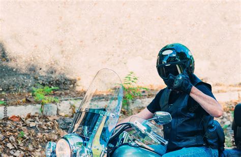 Biker In Leather Vest And Thumb Up Riding His Custom Motorcycle Stock