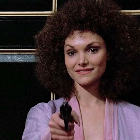 Download Mary Elizabeth Mastrantonio Holding Pistol Wallpaper