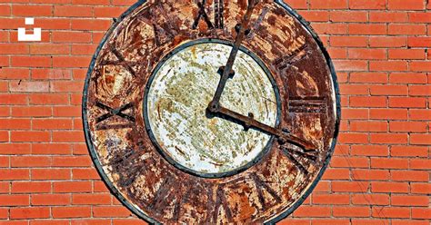 A Rusted Clock On A Brick Wall Photo Free Clock Image On Unsplash