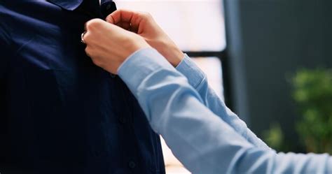 Premium Photo Worker Arranging Shirt On Mannequin Checking Stylish