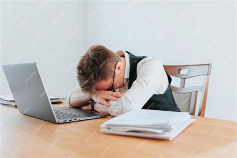 Premium Photo A Tired Office Worker Takes A Nap At His Desk Exhausted