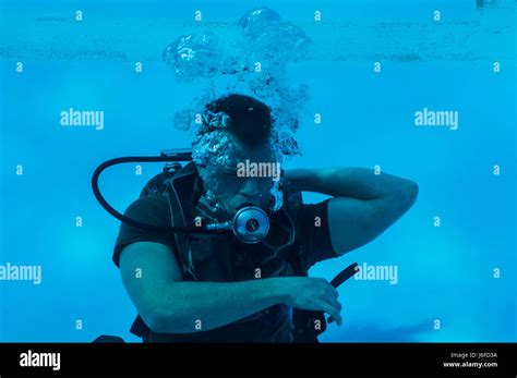 Cpl Kaleb Kinker Adjusts His Scuba Gear After Interference From An Instructor Simulating Rough