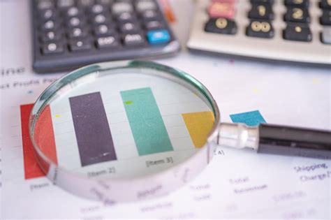 Premium Photo Magnifying Glass On Charts Graphs Paper