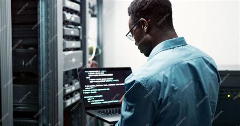 premium photo server room black man or coding with laptop for system