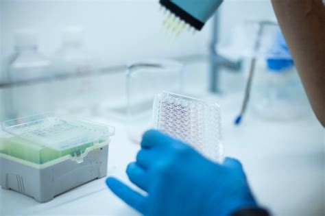 Premium Photo In Vitro Cellular Assay Using Multi Pipette And Well