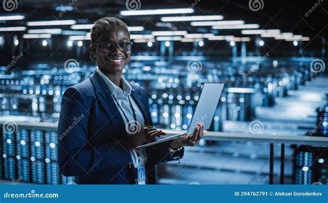 data center female programmer using laptop computer smiling and