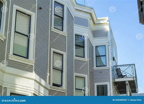 Building Facade With Wooden Pannels And White Accent Paint Around
