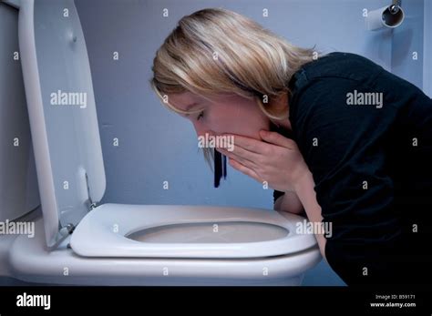 Young Woman Teenage Girl Being Sick Vomiting Into Toilet Bowl Morning