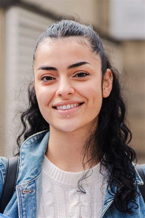 Vertical Portrait Of A Pretty Hispanic Female Student Smiling And