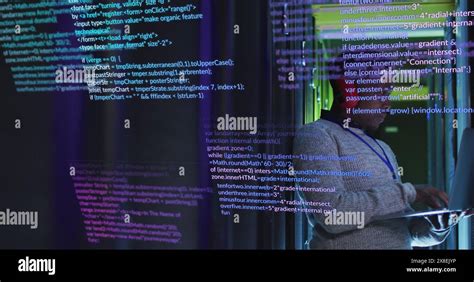 An African American Man In His Early Thirties Is Working On Laptop Surrounded By Code On A