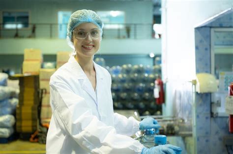 Premium Photo Female Quality Control Workers In A Drinking Water Factory Inspecting The