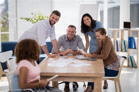 Team of Executives Interacting with Each Other while Working in the Office Stock Photo - Image ...