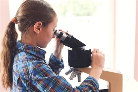 Premium Photo Babegirl Looking In Microscope During Lesson Of Chemistry Or Biology In Babe