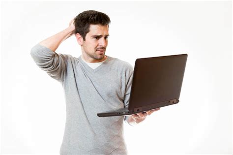 premium photo man holding laptop while standing against white background