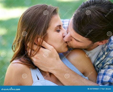 Isnt Young Love Beautiful A Young Couple Kissing In The Park Stock