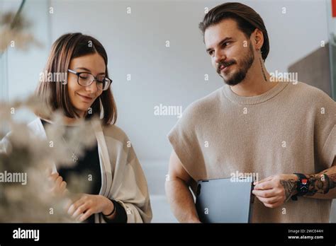 Young Professionals Collaborating In A Modern Office Analyzing Statistics And Planning Project