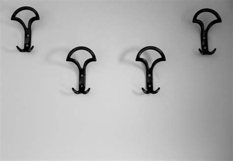 Premium Photo Close Up Of Hooks Mounted On White Wall