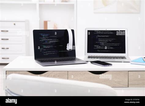 Programmers Workplace Modern Laptops With Unfinished Code Headphones