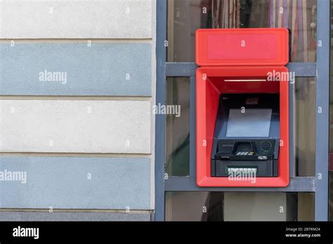 A Red Atm Is Embedded In The Wall Of The Building Automated Teller Machine In The City Street