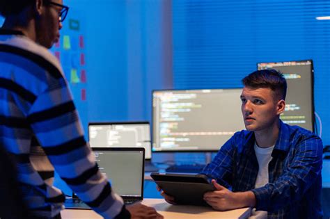 A Group Of Programmers Engage In A Productive Discussion About Coding