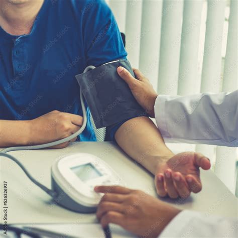 Female Doctors Use Blood Pressure Monitors And Stethoscope To Measure