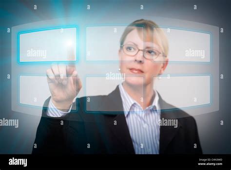Attractive Blonde Woman Using An Interactive Touch Screen Stock Photo Alamy